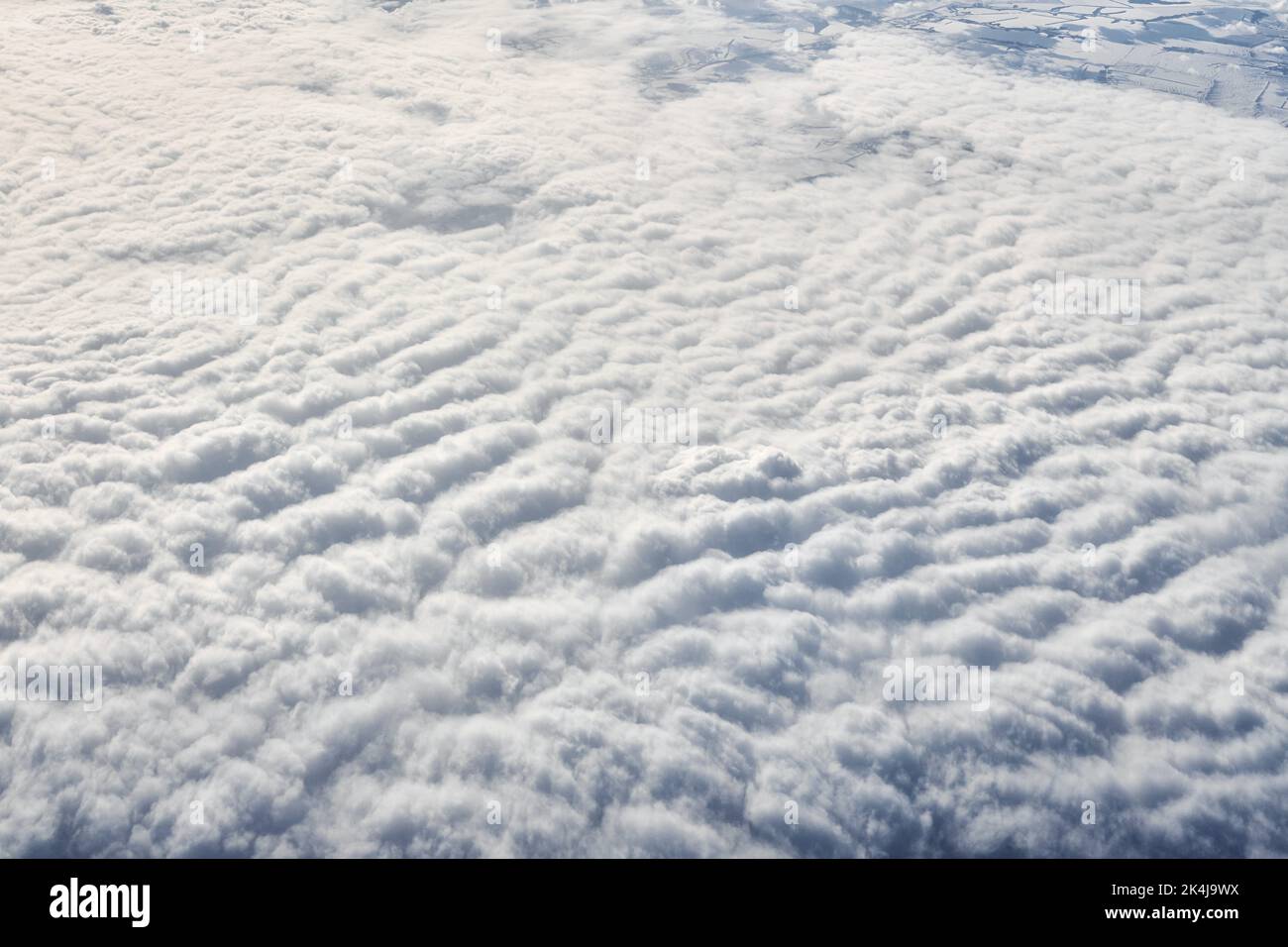 Breathtaking over clouds view from aircraft window, thick white blue ...