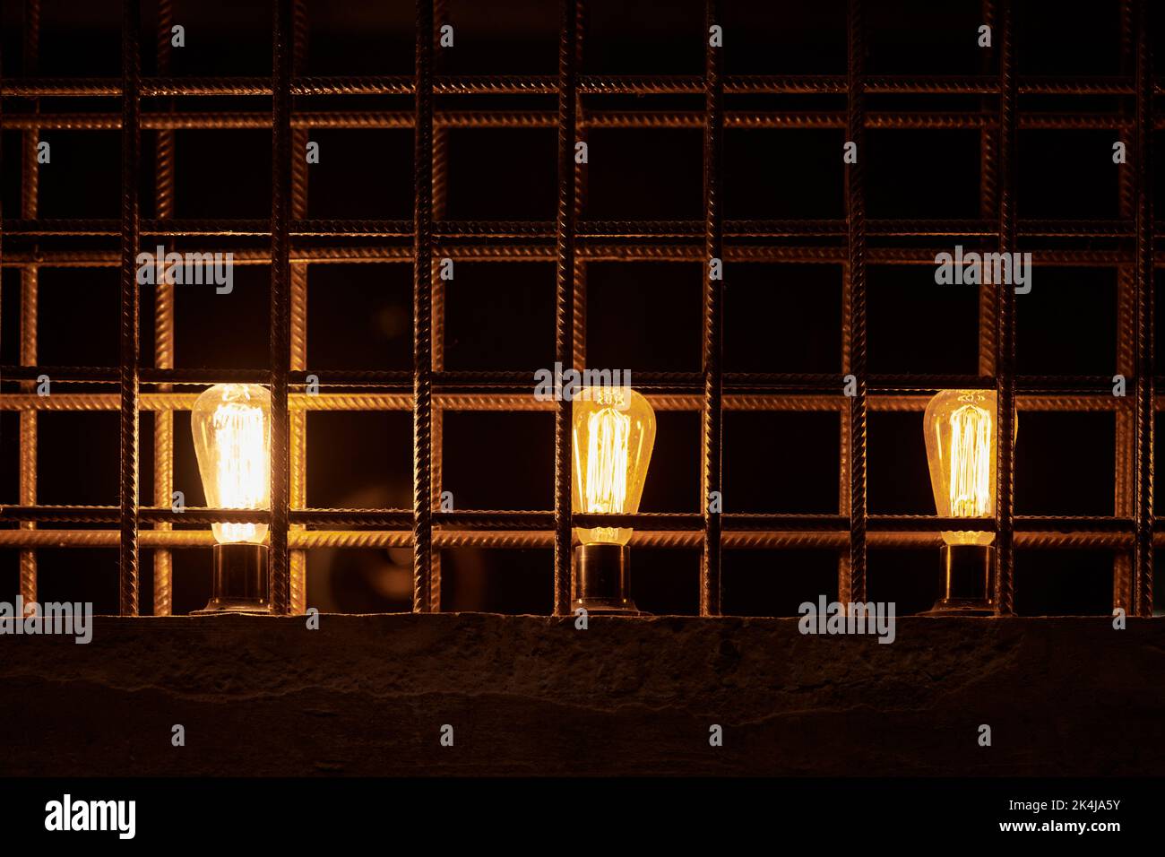 Three decorative incandescent light bulbs inside loft partition from ...