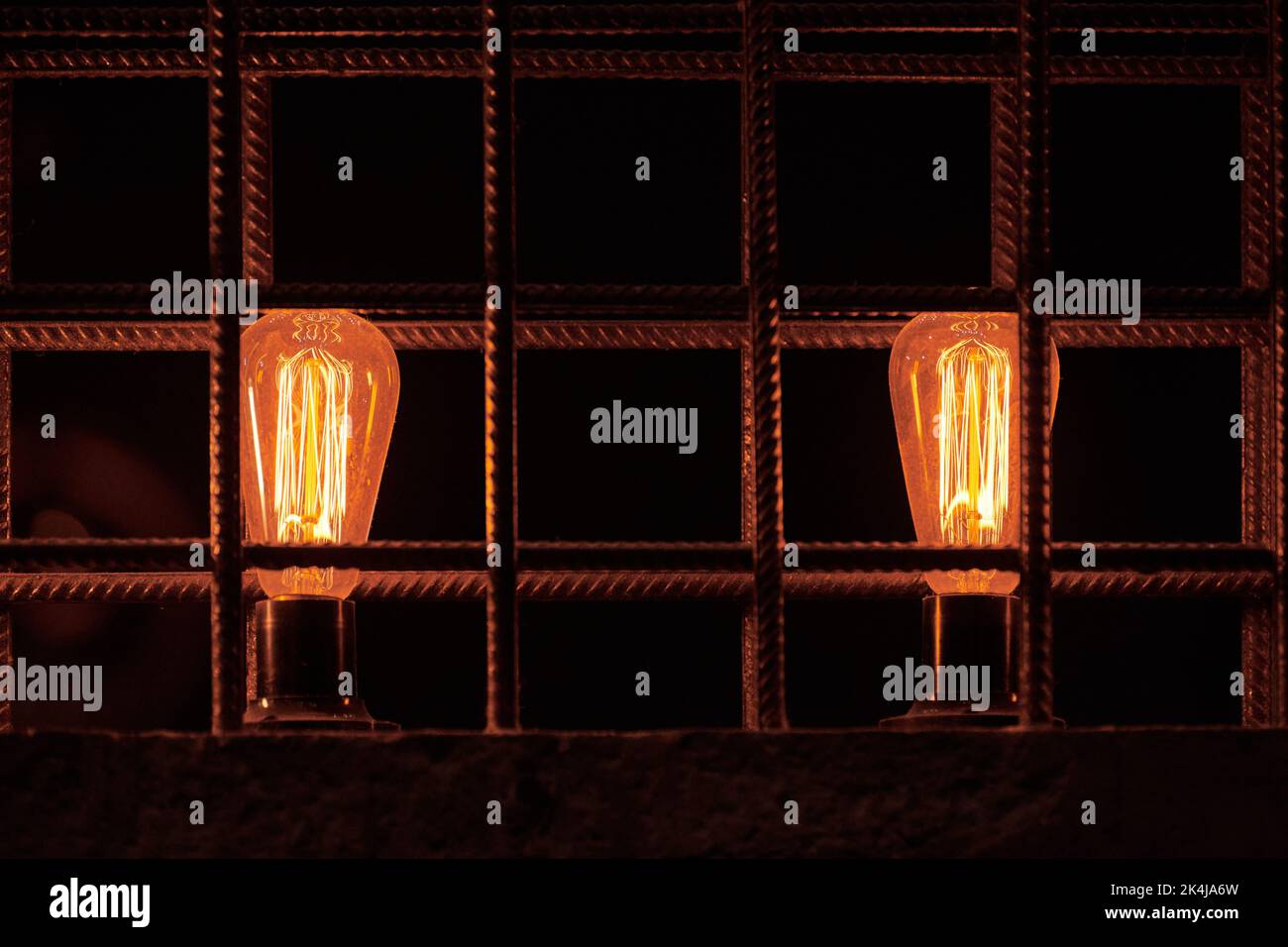 Two decorative incandescent light bulbs inside loft partition from ...