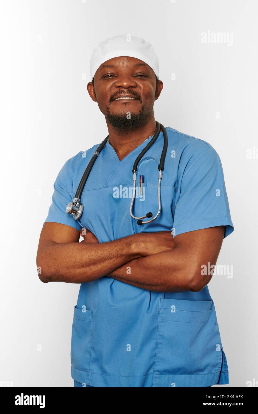 Smiling black surgeon doctor bearded man in blue coat and medical cap ...