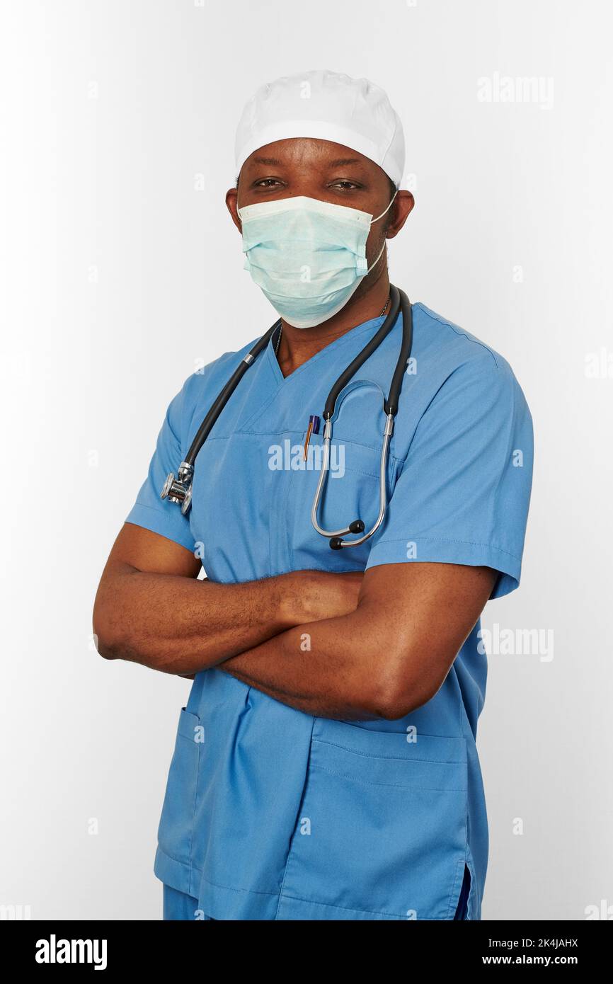 Black surgeon doctor man in blue coat white cap and surgeon mask with ...