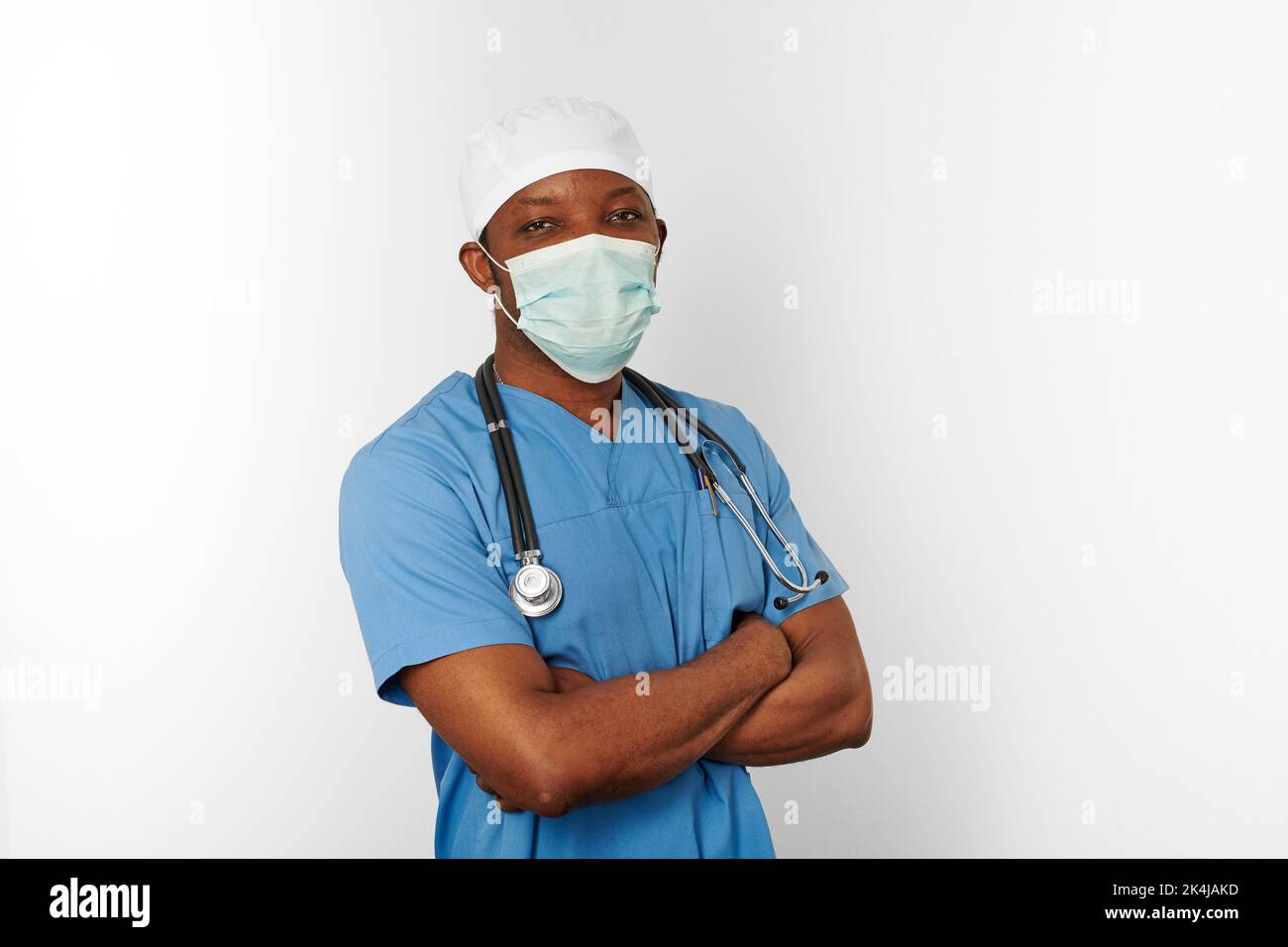 Black surgeon doctor man in blue coat white cap and surgeon mask with ...