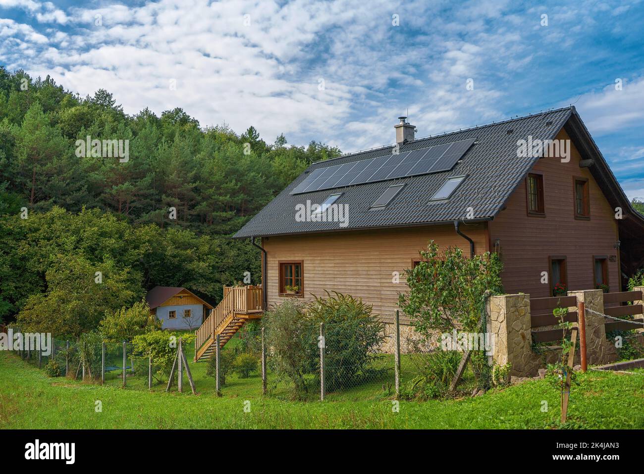 Wooden house with installed solar panels. Alternative energy, saving ...
