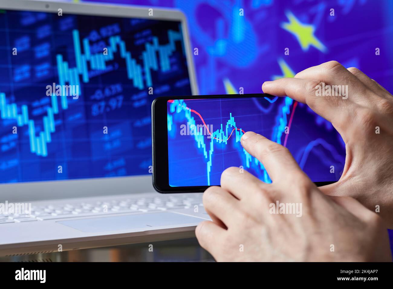 Trader analyzes stock market data in smartphone on the background of ...