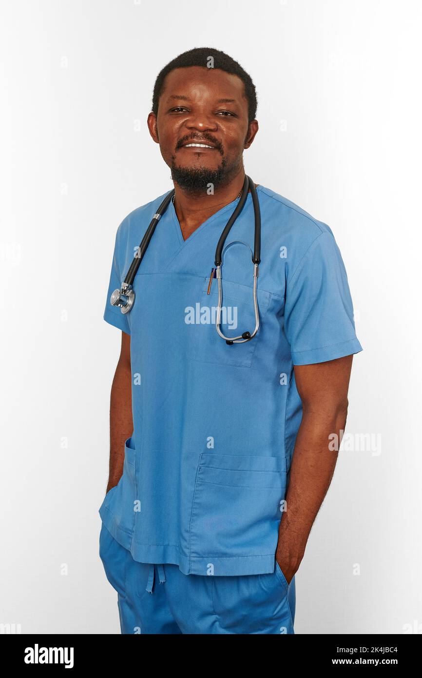 Smiling black surgeon doctor bearded man in blue coat with stethoscope ...