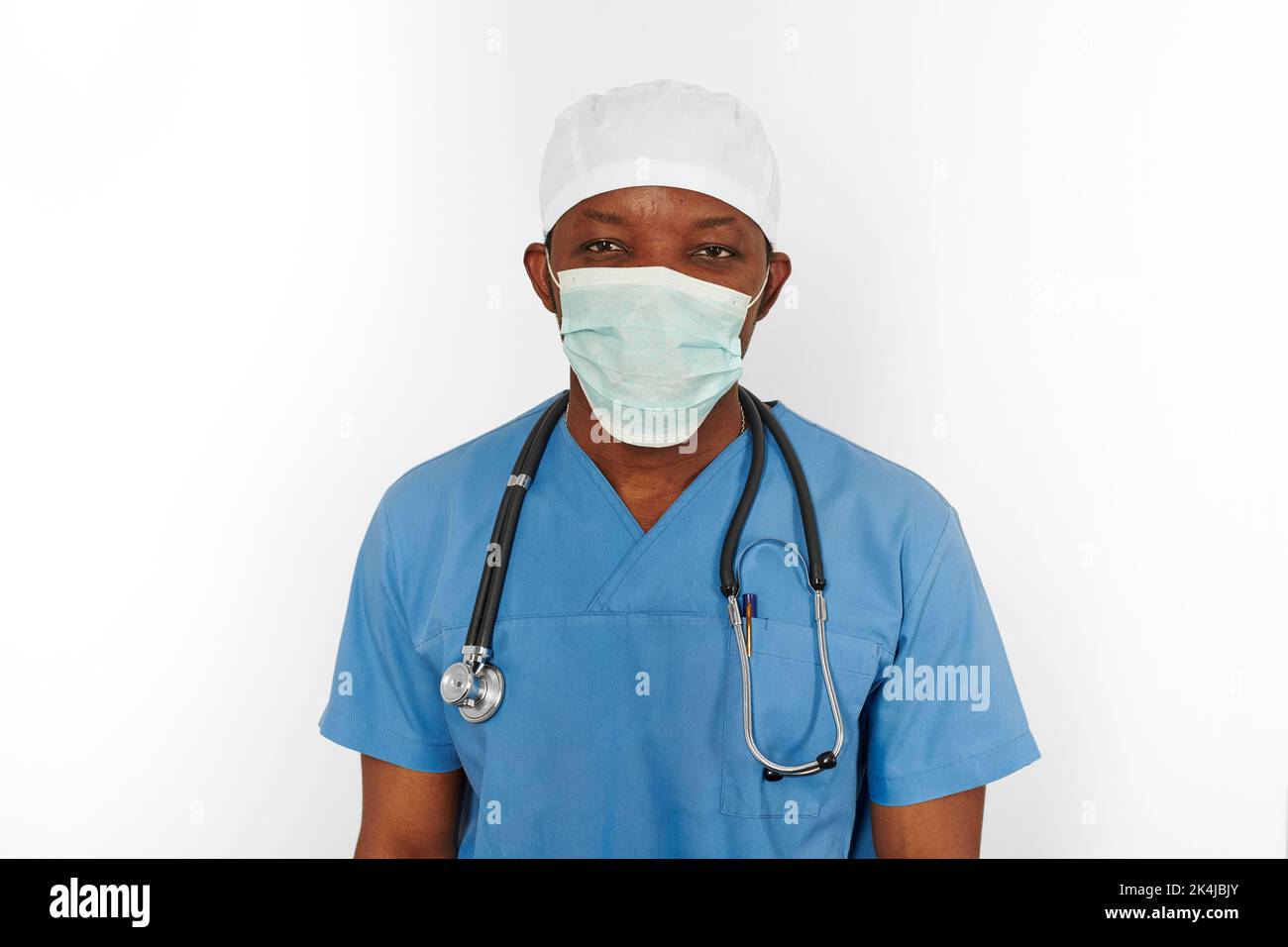 Black surgeon doctor man in blue coat white cap and surgeon mask with ...