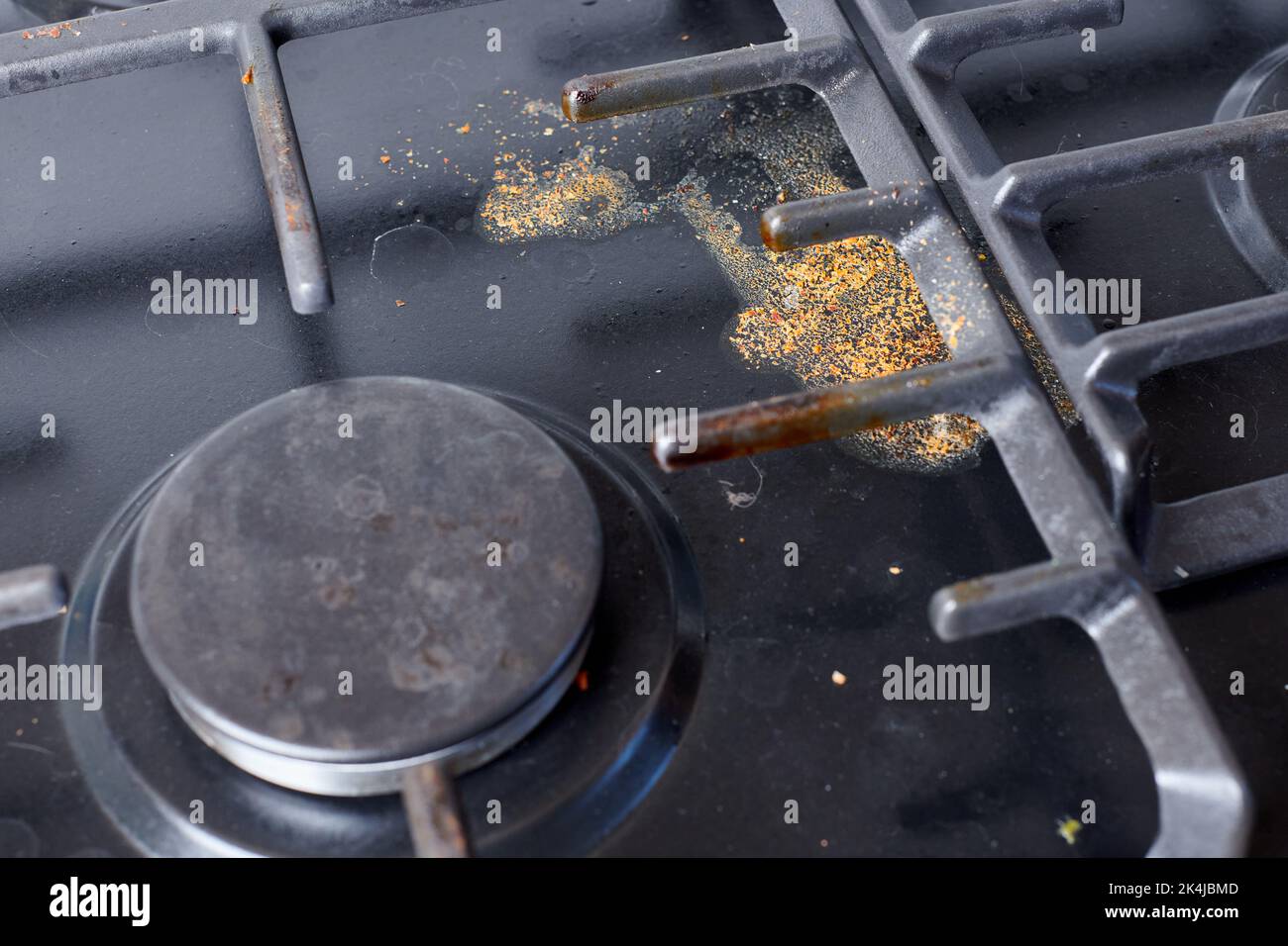 Dirty unclean kitchen black stove with dried food spots, fat stains and ...