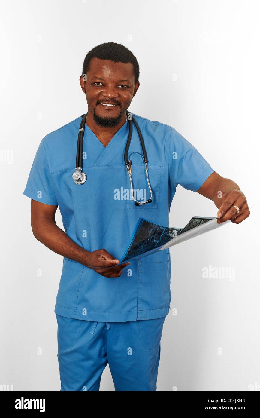 Smiling black surgeon doctor bearded man in blue coat with stethoscope ...