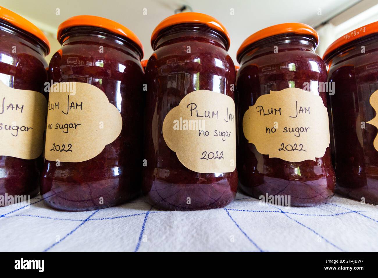 Homemade plum jam in jars labelled: Plum jam no sugar Stock Photo - Alamy