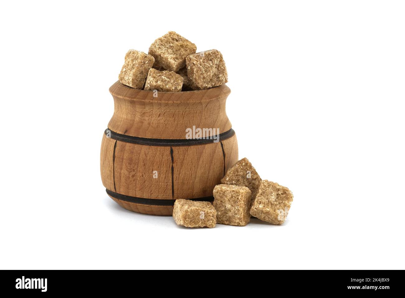 Brown sugar cane cubes in wooden bowl isolated on white background ...