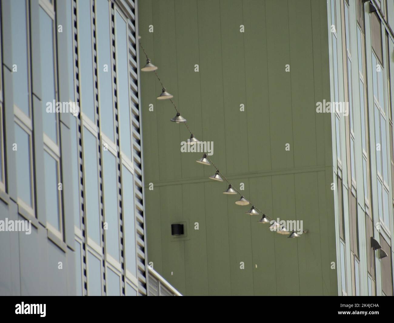 Creative lantern garland hanging between two high-rise buildings Stock ...