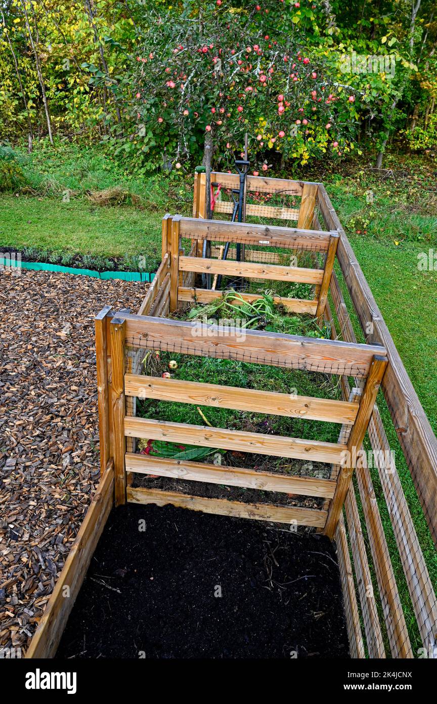 garden compost with three compartments in garden Stock Photo - Alamy
