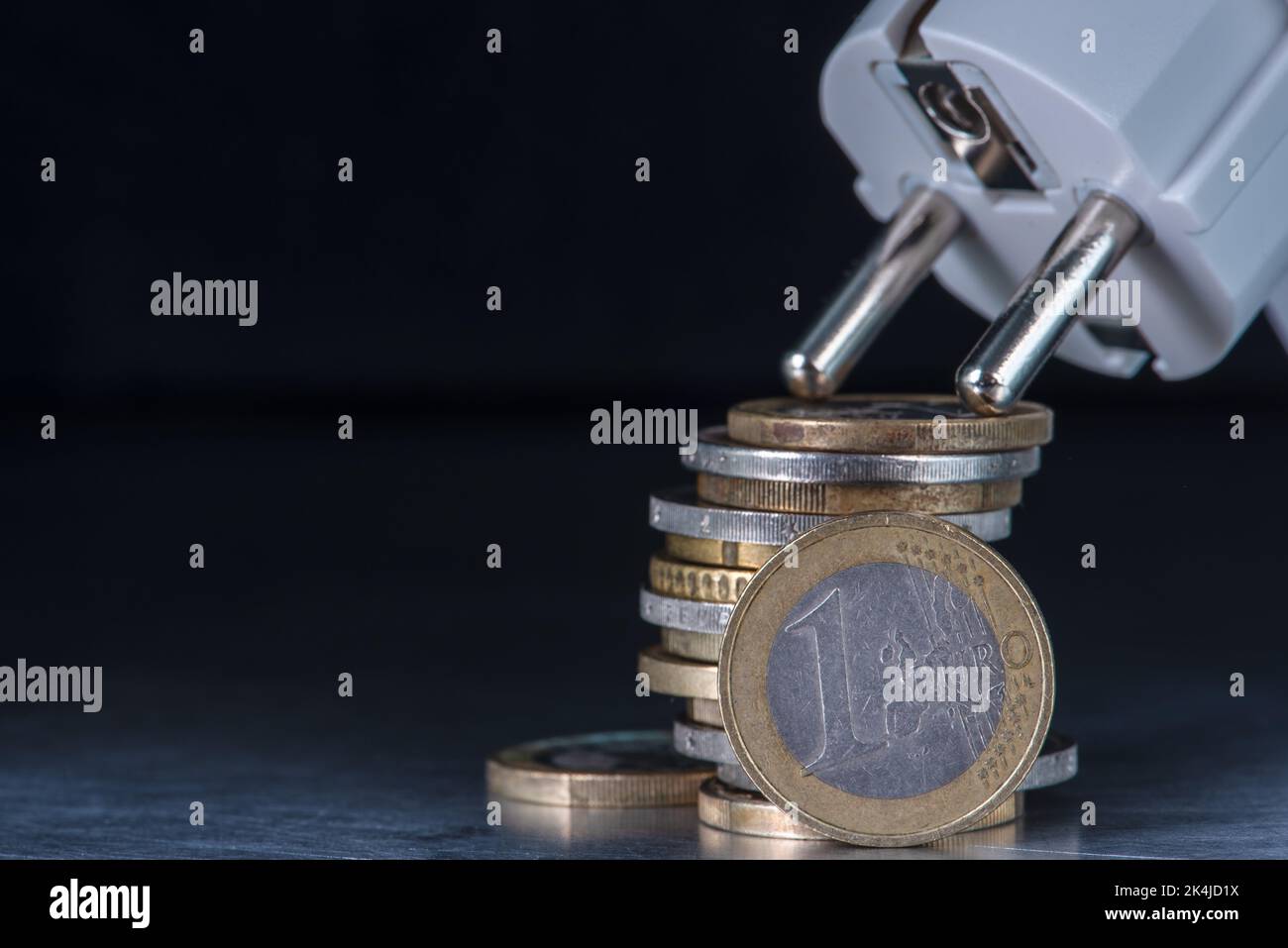 Concept of increasing electricity prices, pile of euro coins and ...
