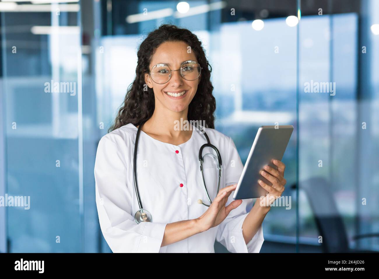 Portrait of a Latin American female doctor. Standing in the corridor of ...