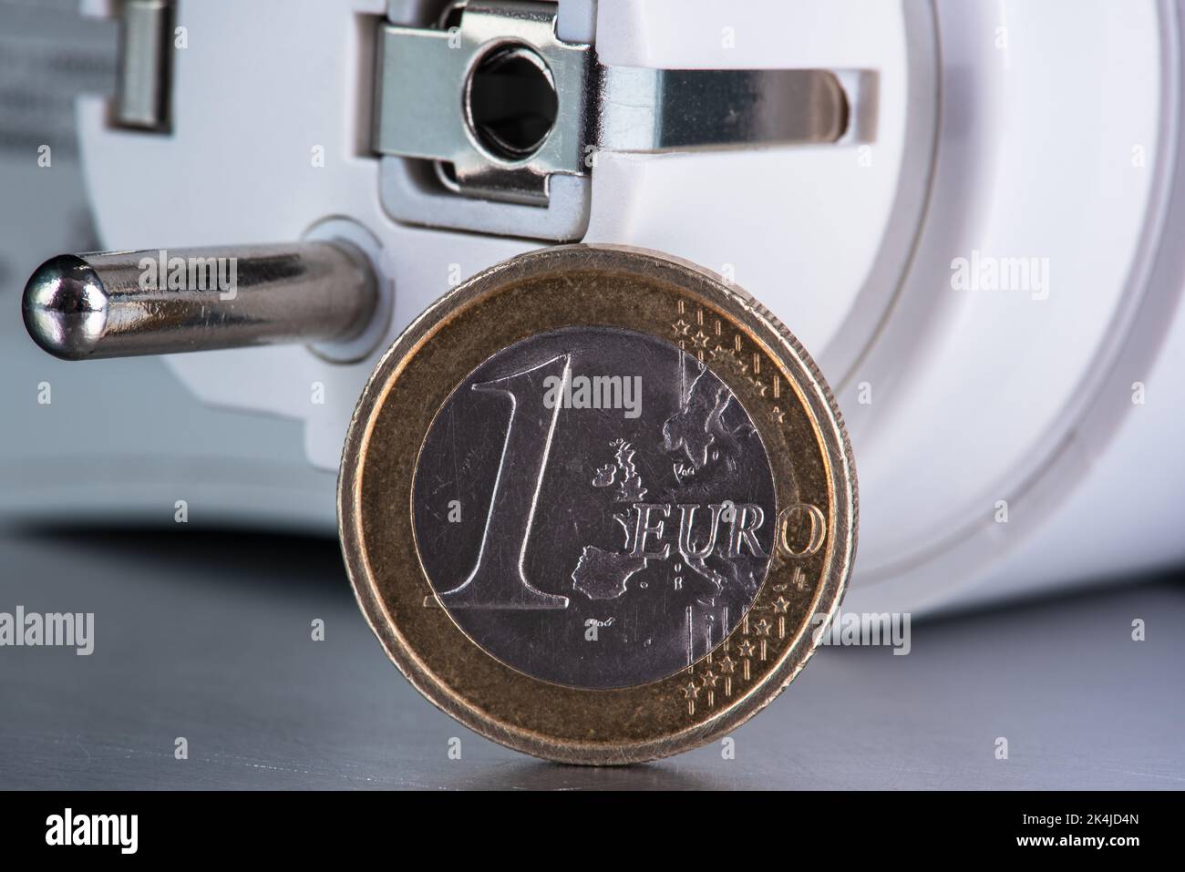 Electric plug and euro coin, concept of increasing electricity prices ...