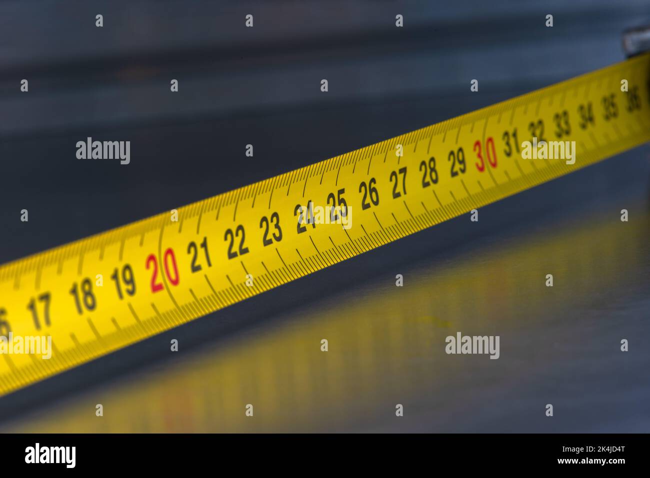 Tape measure close-up on metal workshop table Stock Photo - Alamy