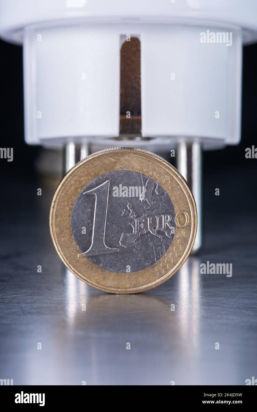 Electric plug and euro coin, concept of increasing electricity prices ...