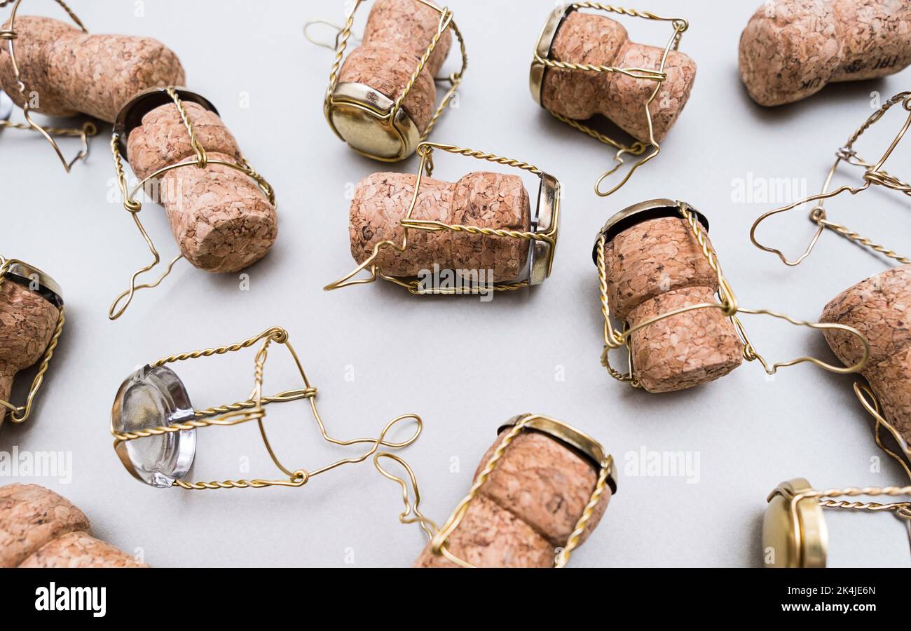 Champagne corks and metal wire muselets on grey background. Collection of bottle caps from ...