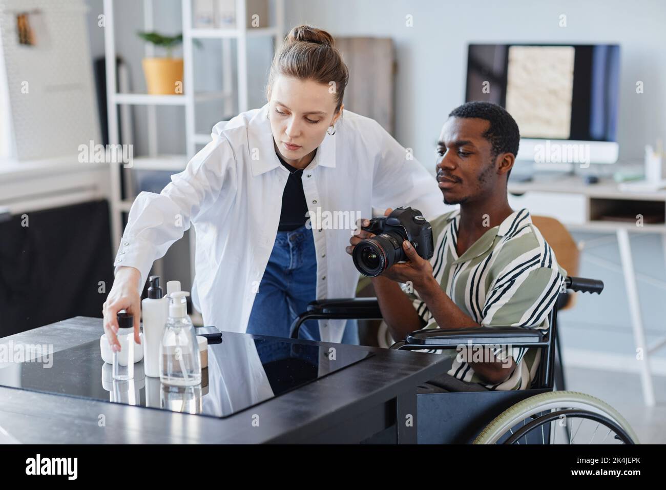 Portrait of young black man with disability as photographer taking ...