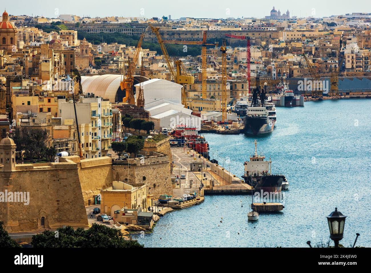 View of old medieval city walls and cargo ships in the harbor of ...