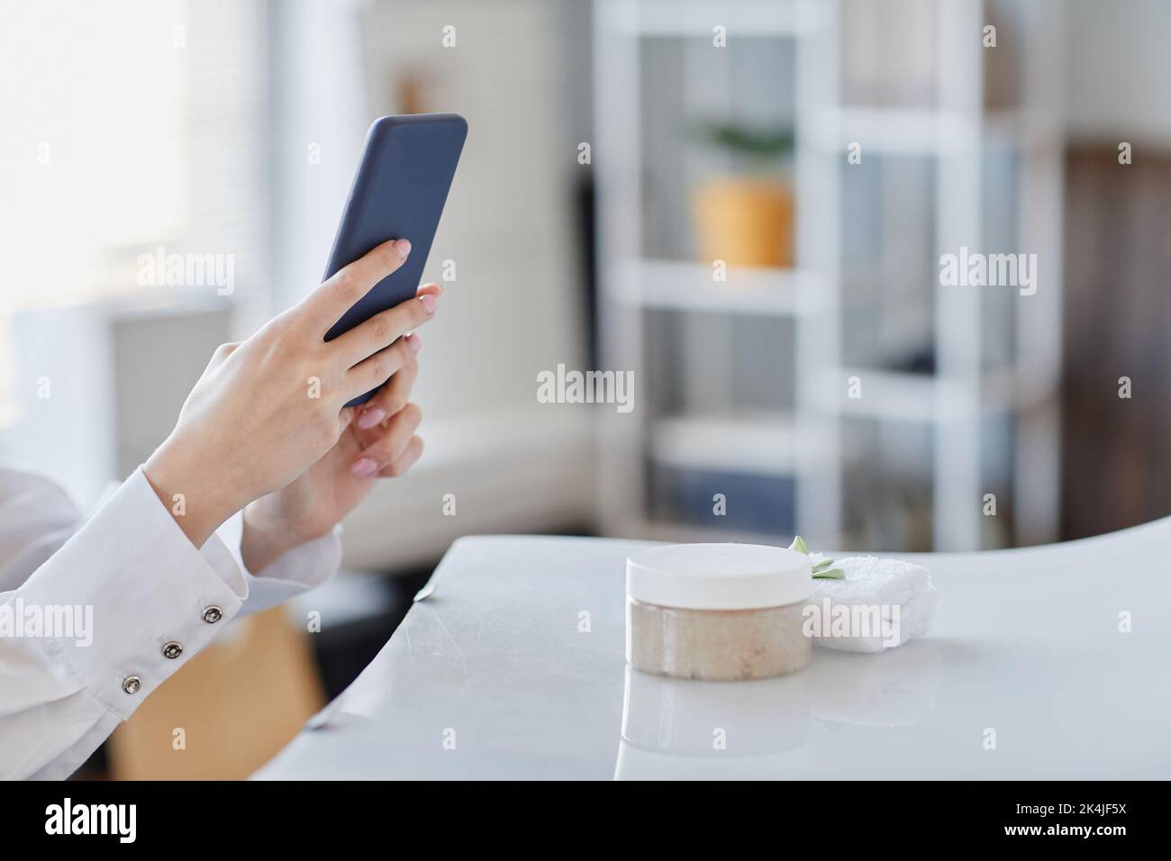 Minimal closeup of young woman taking product images of handmade beauty ...