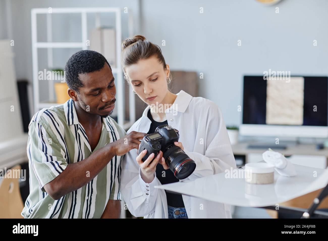 Portrait of two photographers taking product images with professional ...