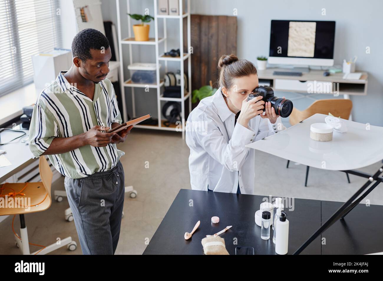High angle portrait of two photographers taking product images with ...