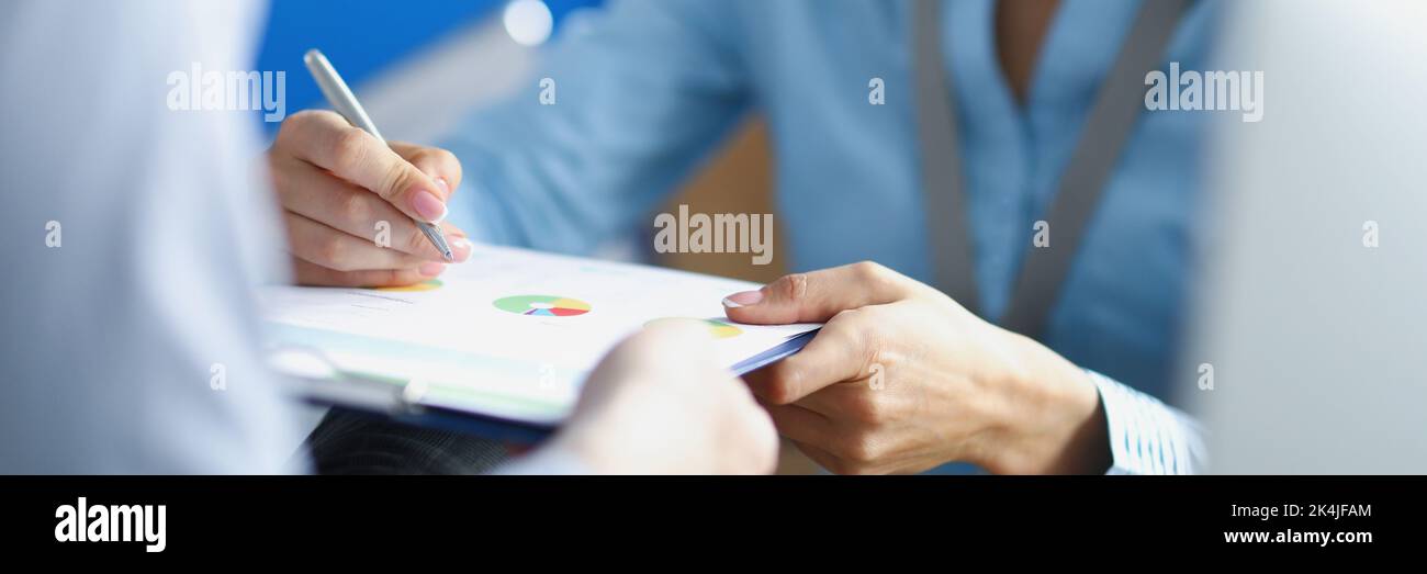 Female worker make correction on business paper with pen Stock Photo ...