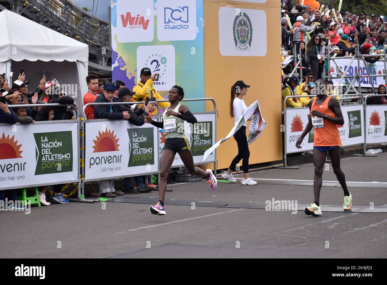 Kenian runner Angela Tanui crosses the finish line first for the 21k ...