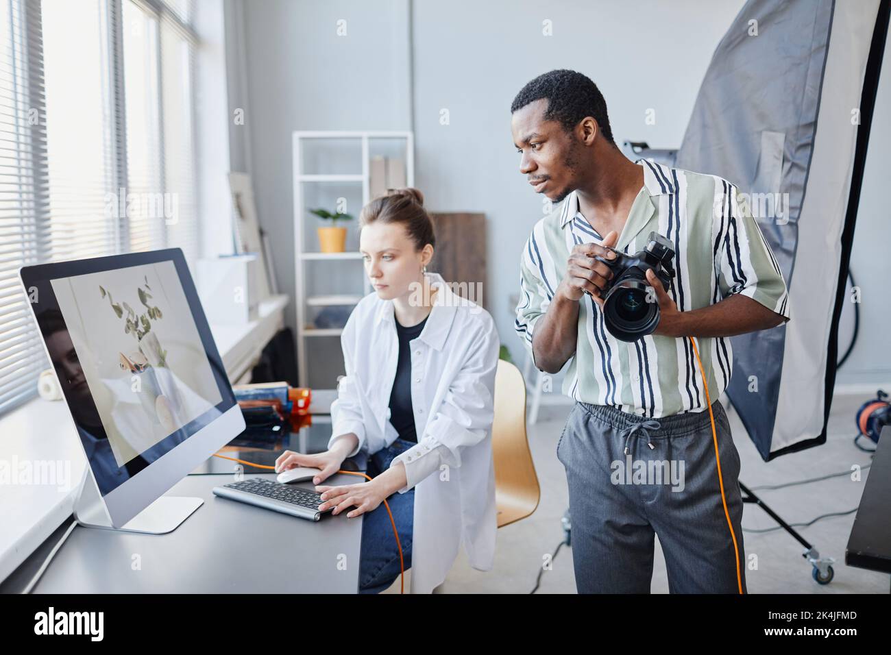 Minimal portrait of two photographers working as team on product ...