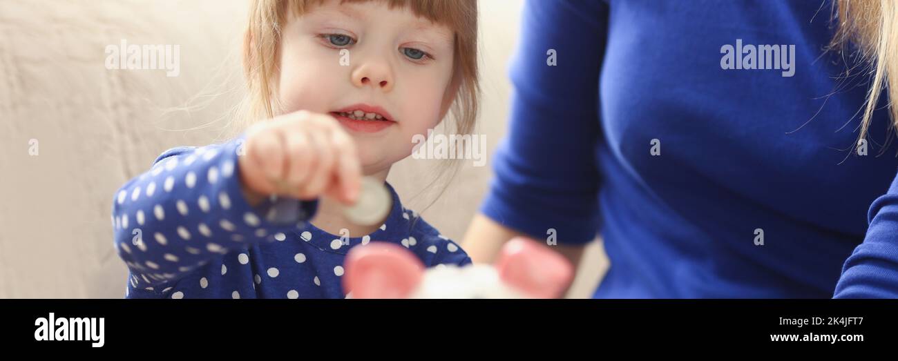 Child little girl putting coin money into piggy bank container Stock ...