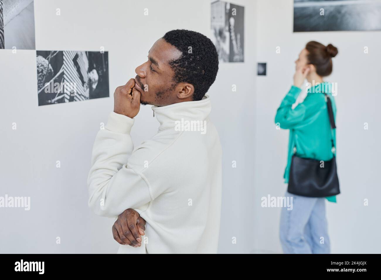 Minimal side view portrait of two people looking at photography in art ...