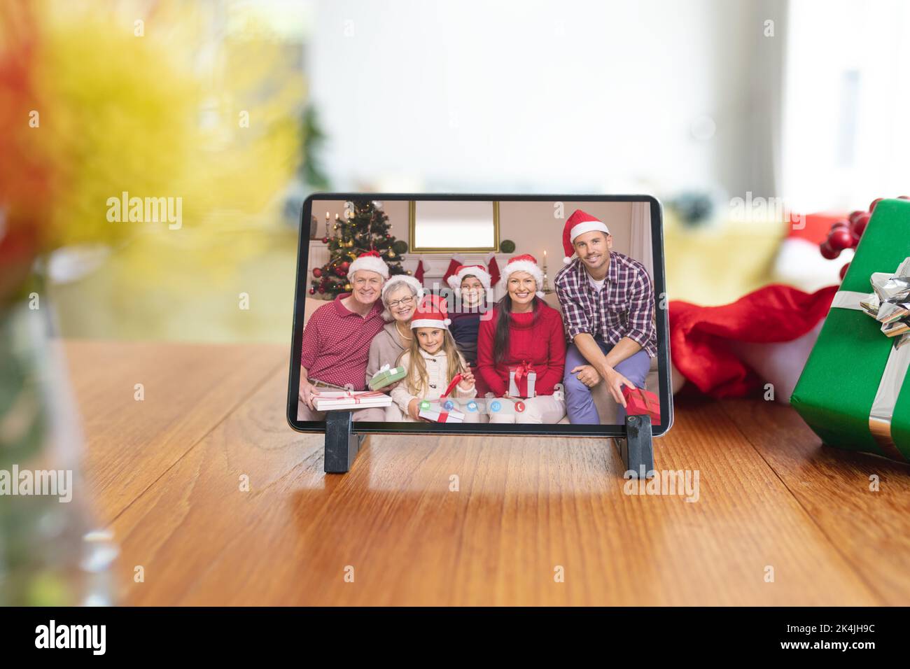 Happy caucasian multi generation family at christmas smiling on tablet ...