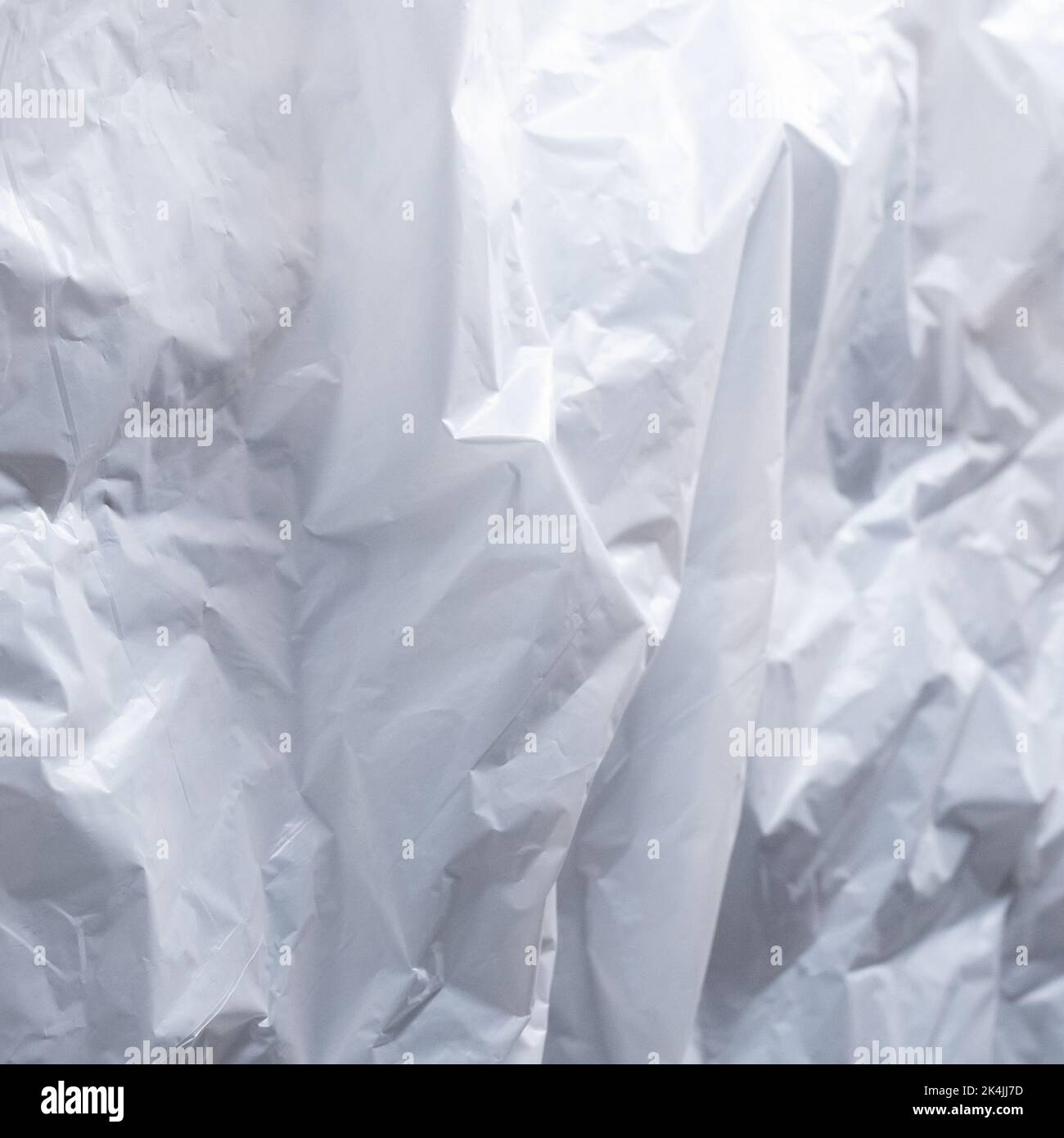 Reflecting light and shadow on creases and folds in scrunched white ...