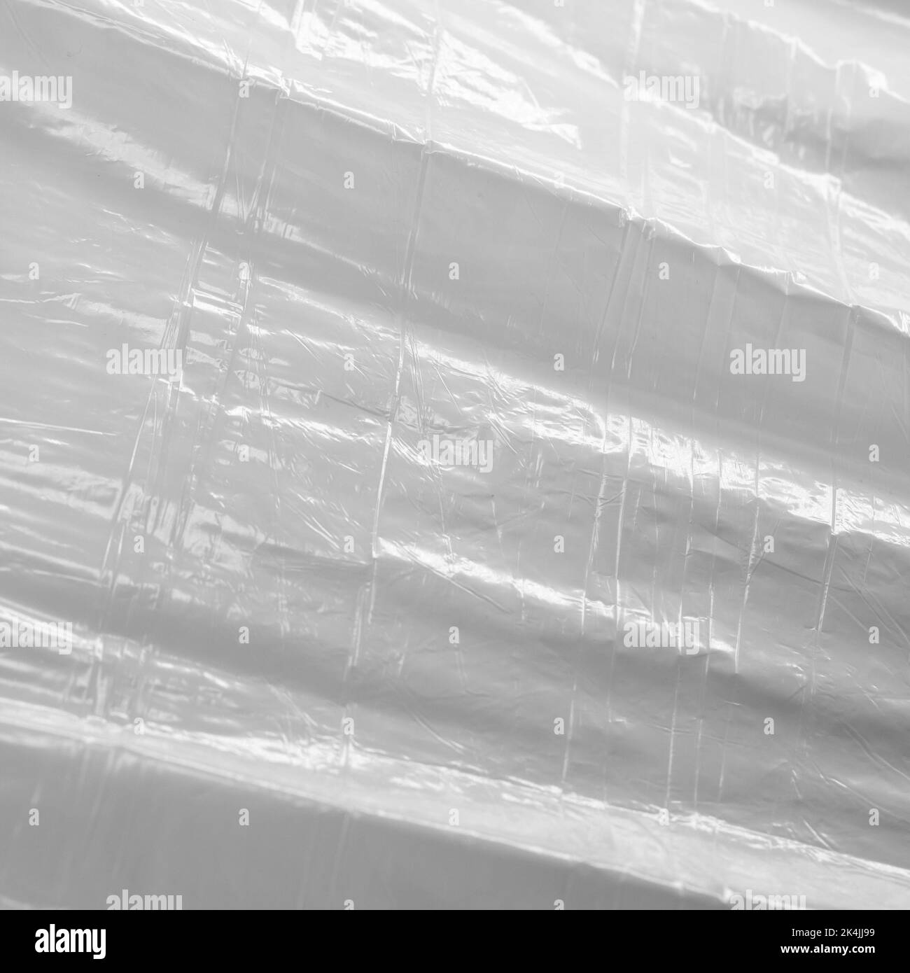 Reflected light and shadow on creases and folds in plastic sheeting ...