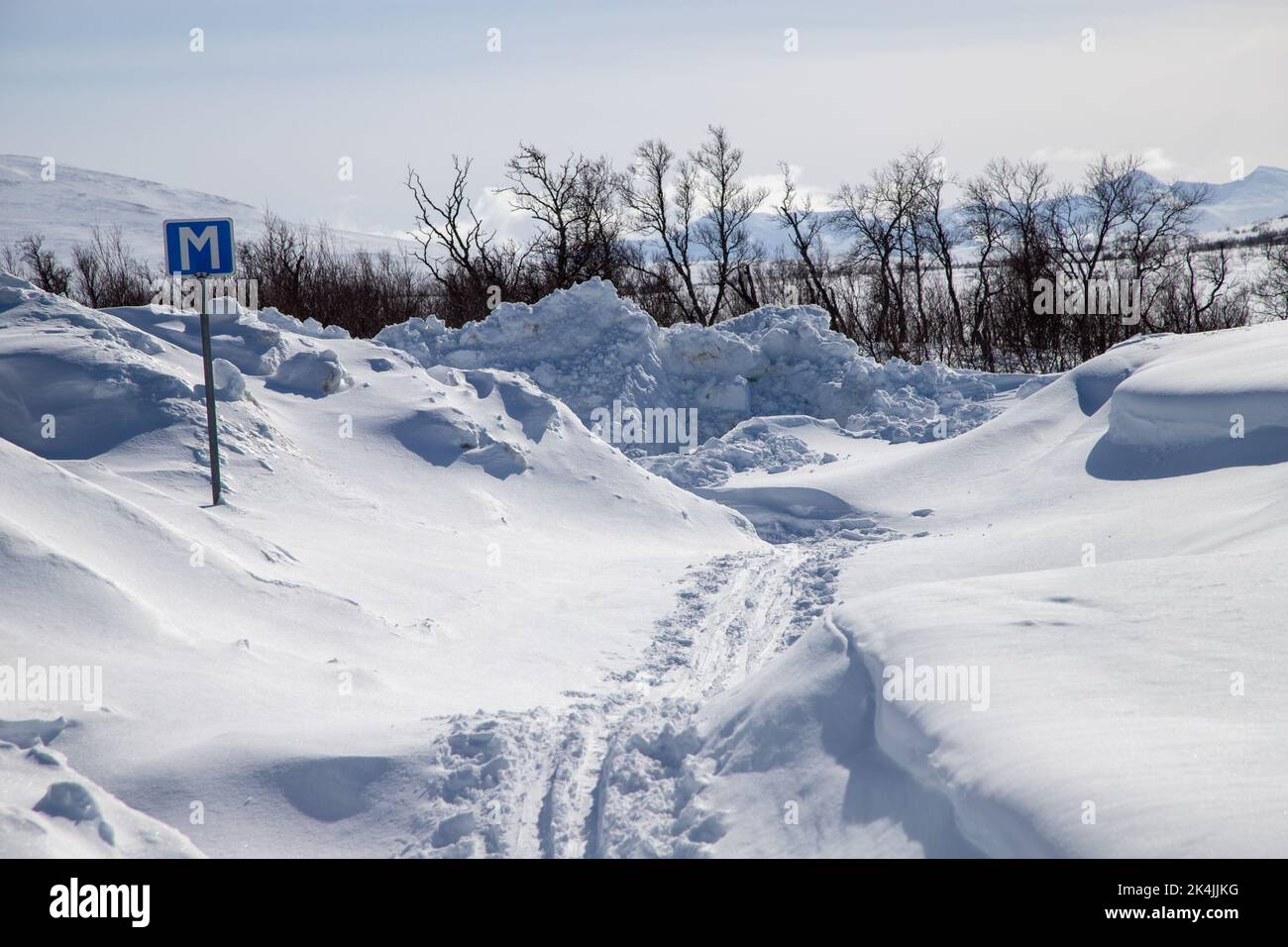 A snow road field with footsteps on a cold winter day Stock Photo - Alamy