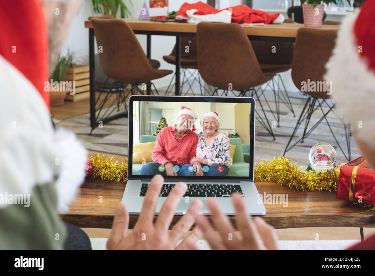 Waving father and daughter making laptop christmas video call with ...
