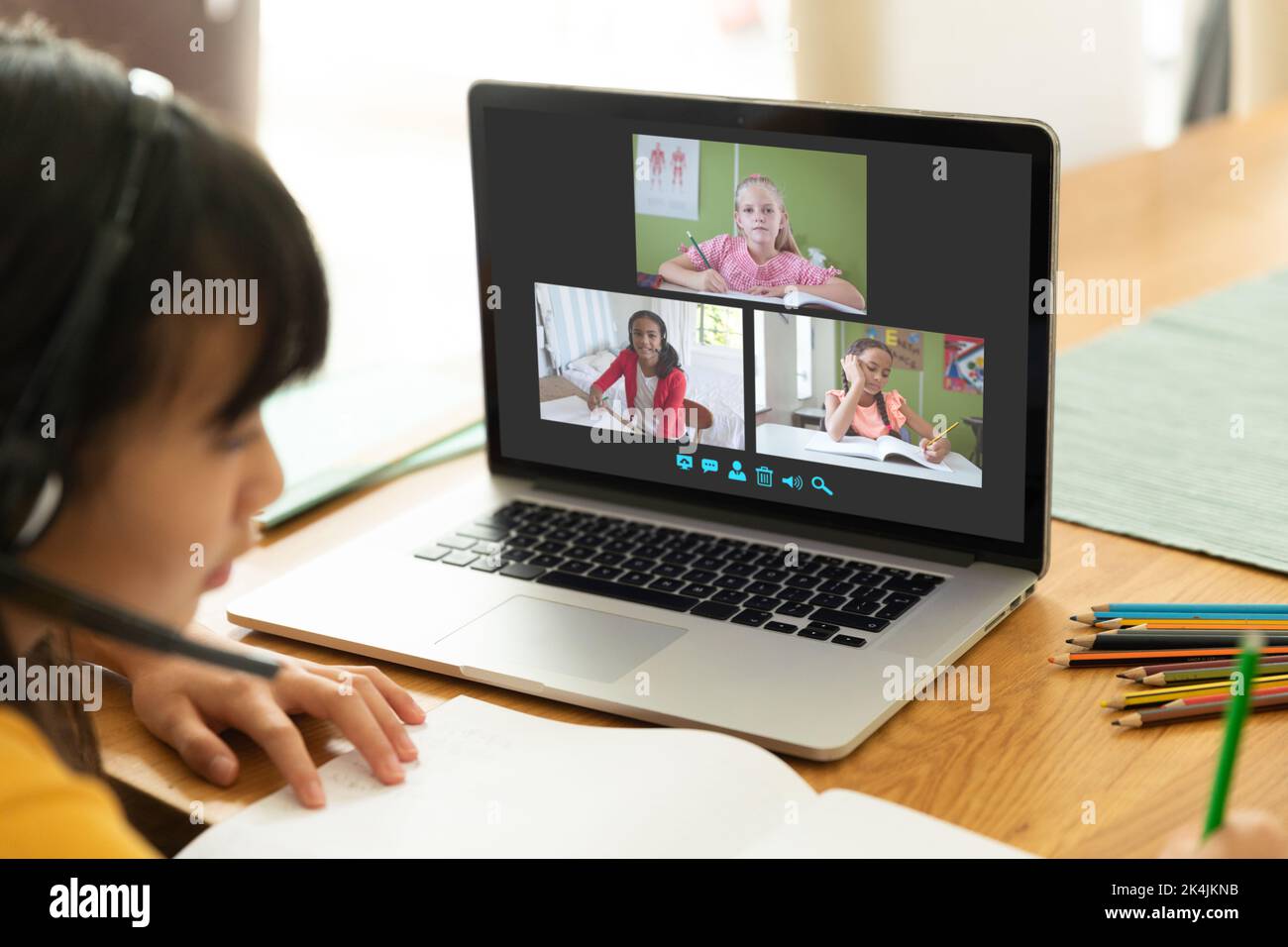 Asian girl using laptop for video call, with smiling diverse elementary ...