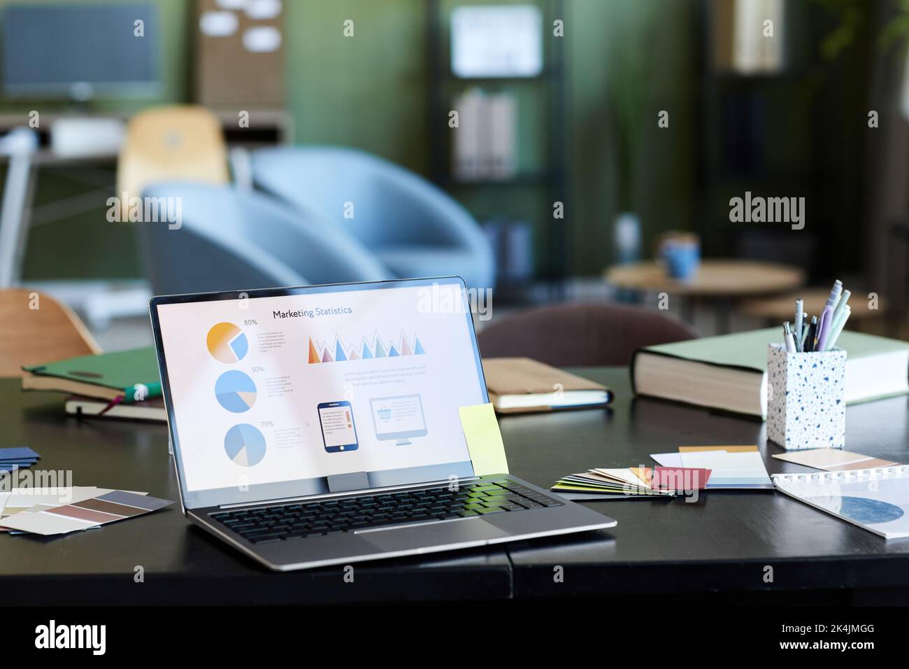 Laptop with financial diagrams and other data on screen standing on ...