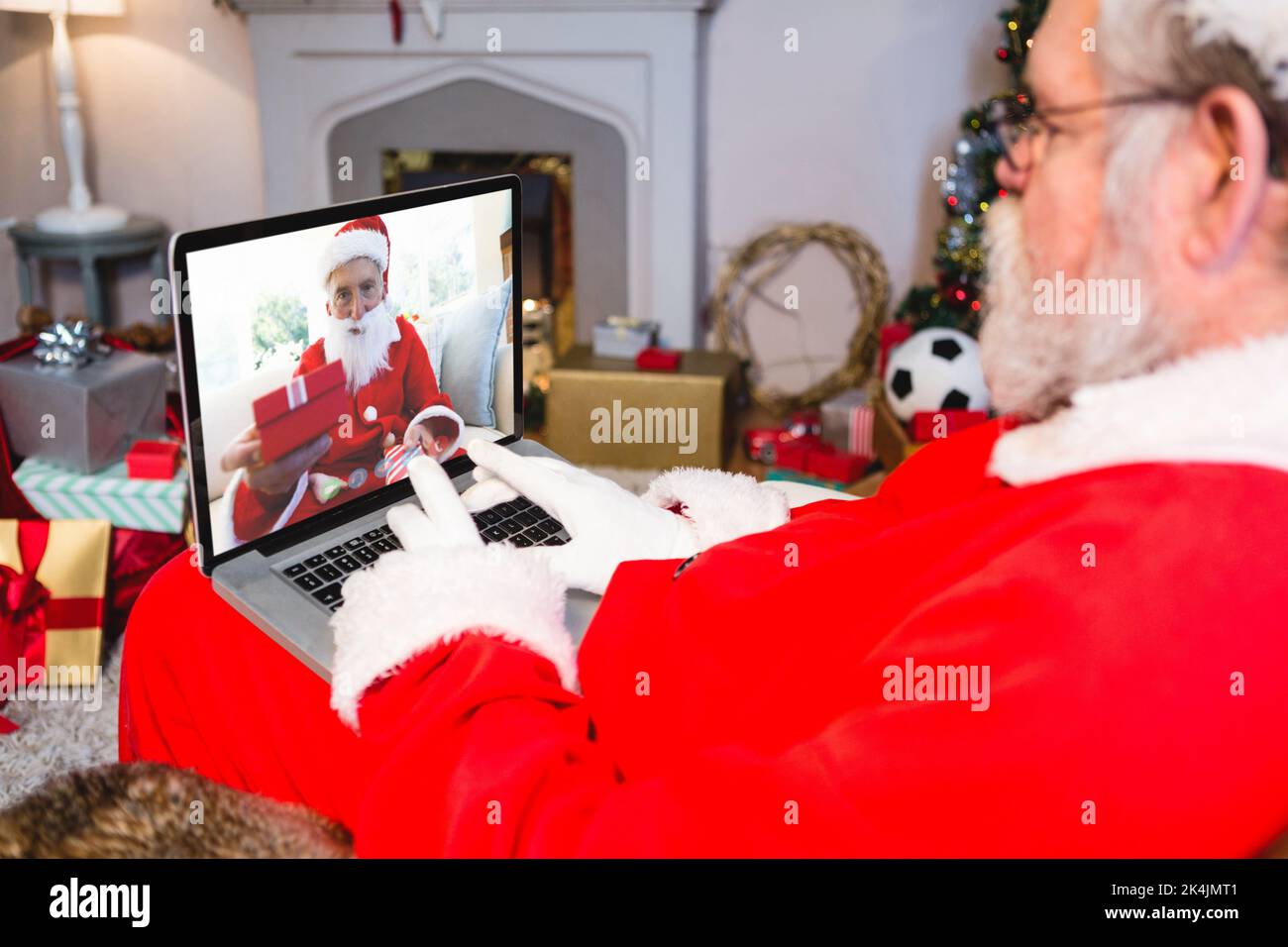 Caucasian santa claus on christmas laptop video call with caucasian ...
