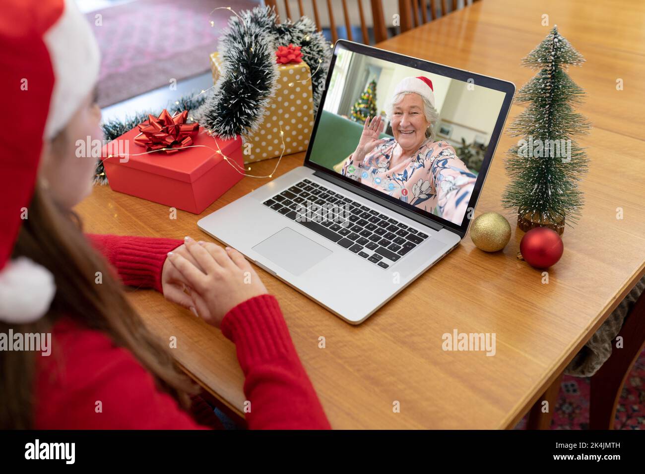 Caucasian woman in santa hat making christmas laptop video call with ...