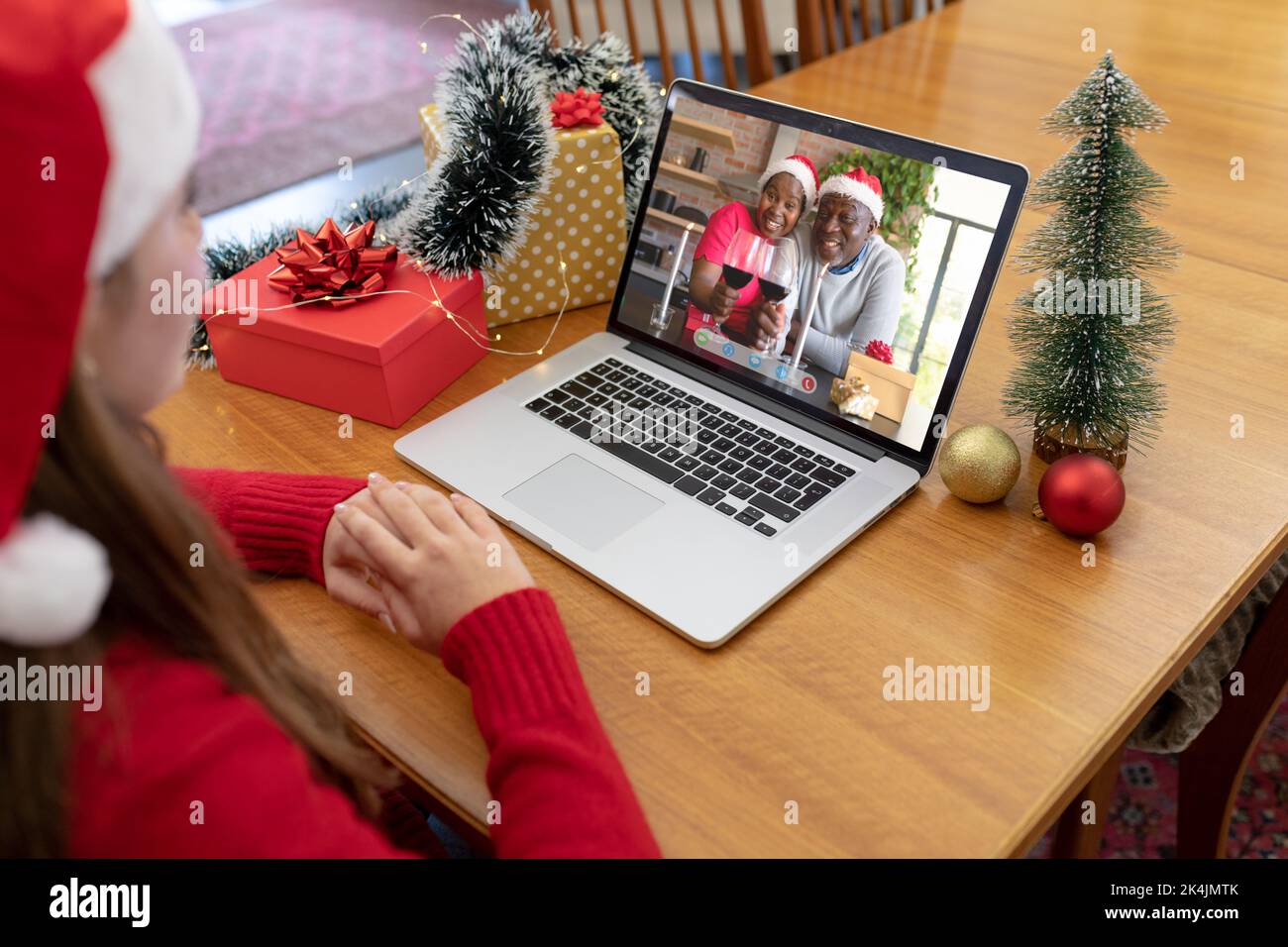 Caucasian woman in santa hat making christmas laptop video call with ...