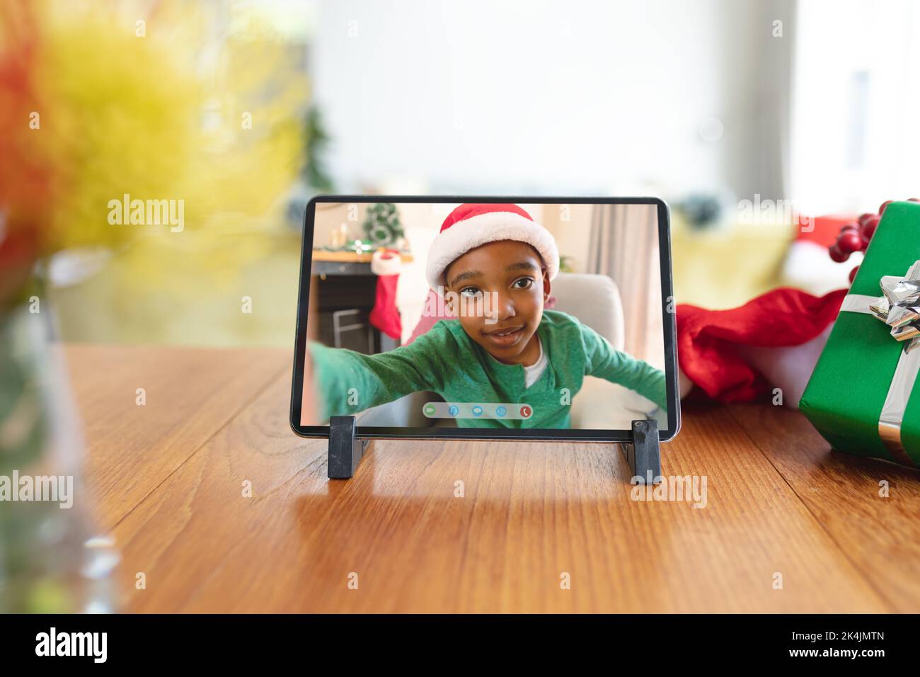 Happy african american boy in christmas santa hat smiling on smartphone ...