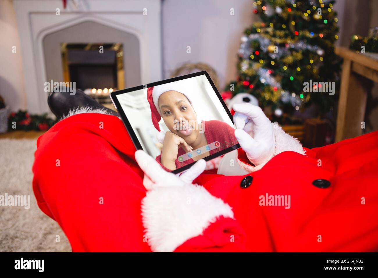 Santa claus making laptop christmas video call with smiling african ...