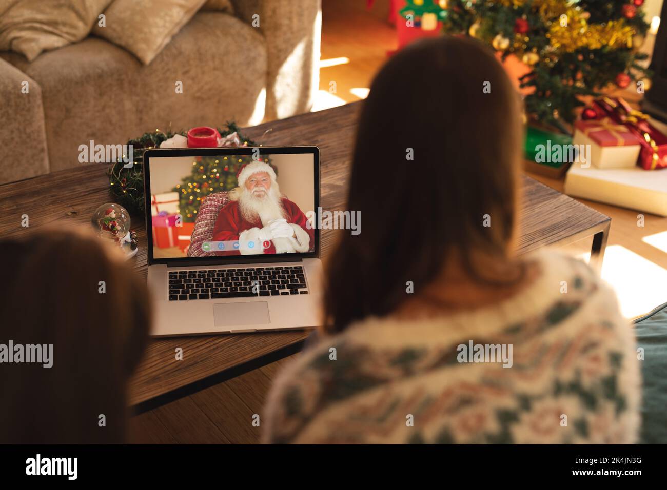 Mother and daughter making laptop christmas video call with smiling ...