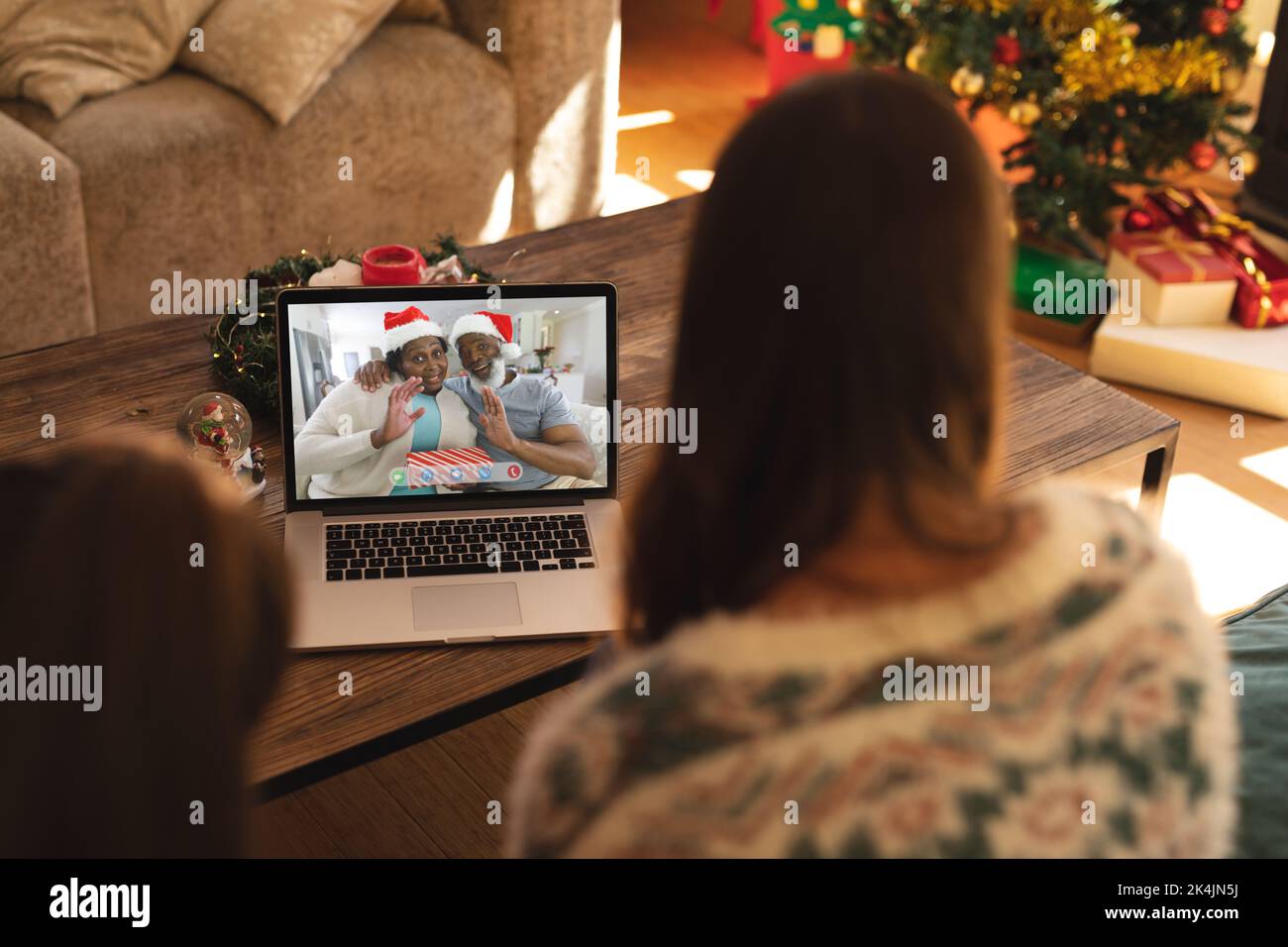 Mother and daughter making laptop christmas video call with happy ...