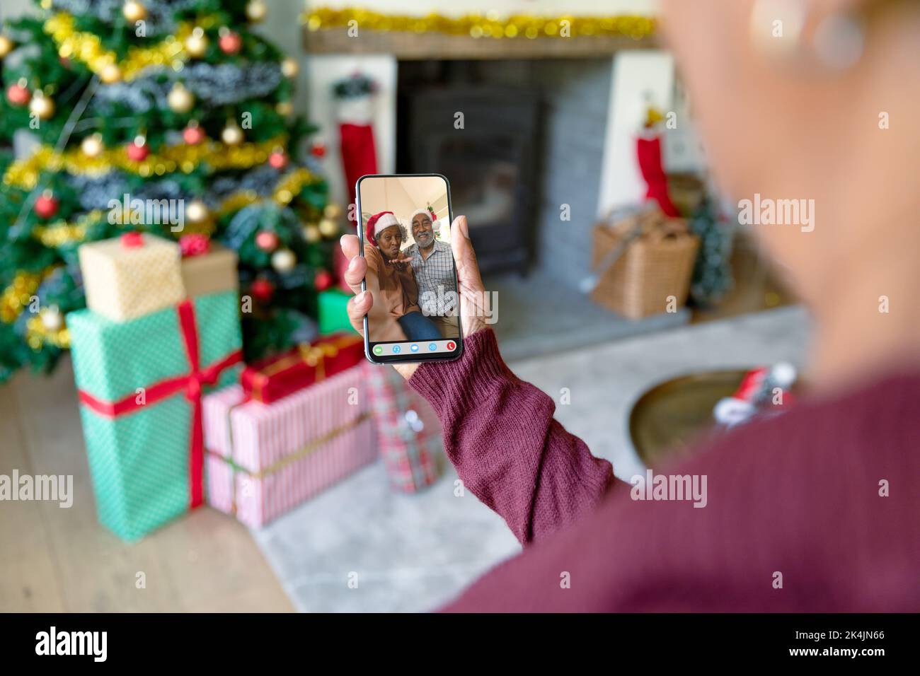 Woman making smartphone christmas video call with smiling senior ...