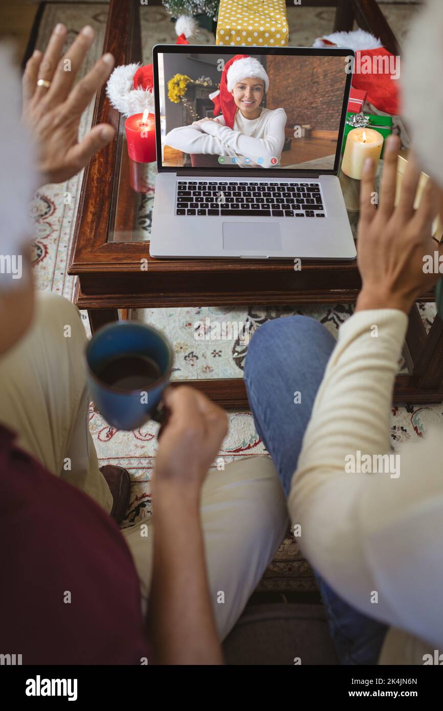 Two waving men making laptop christmas video call with smiling ...