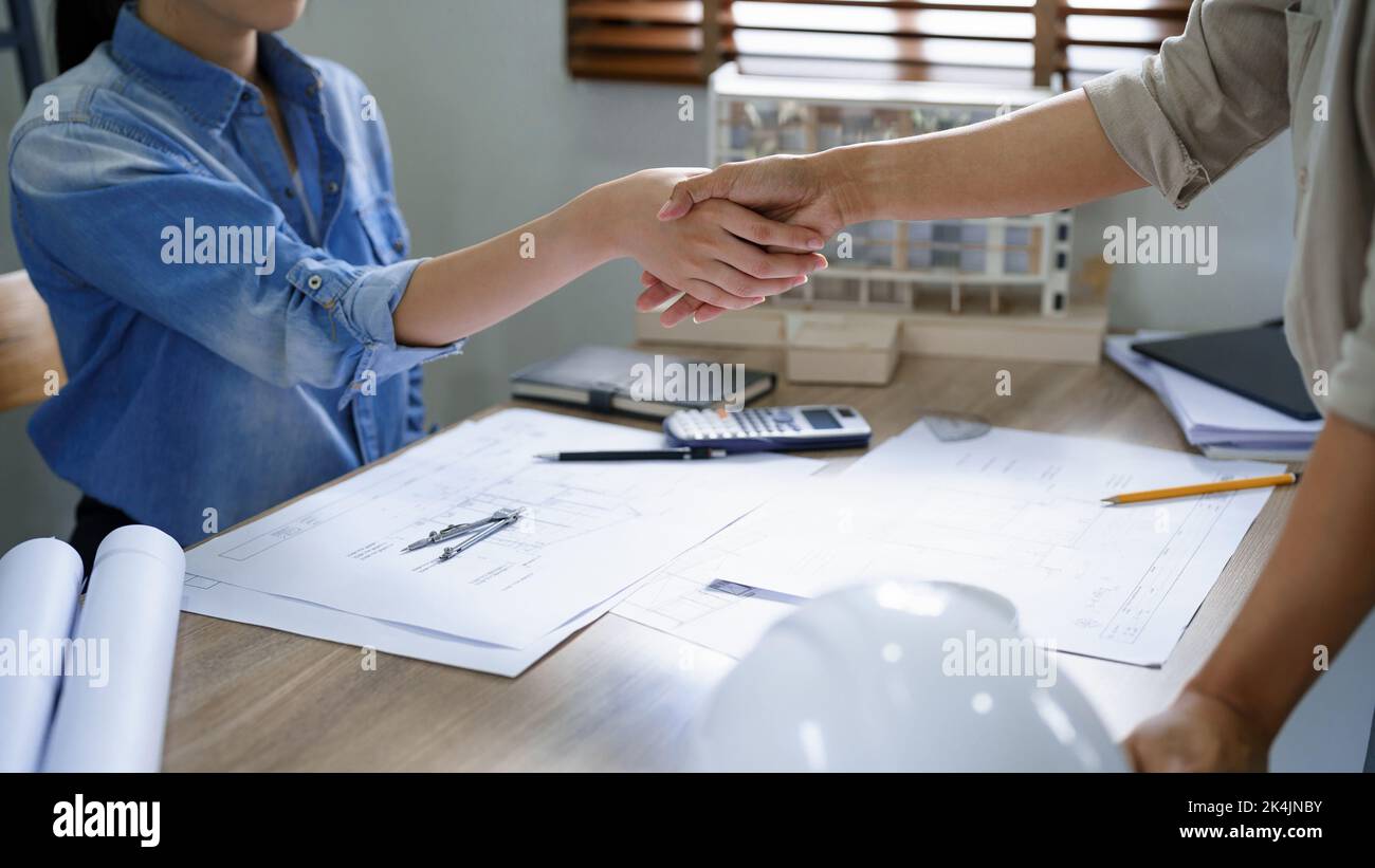 Engineering construction concept, Two female engineers shake hands ...