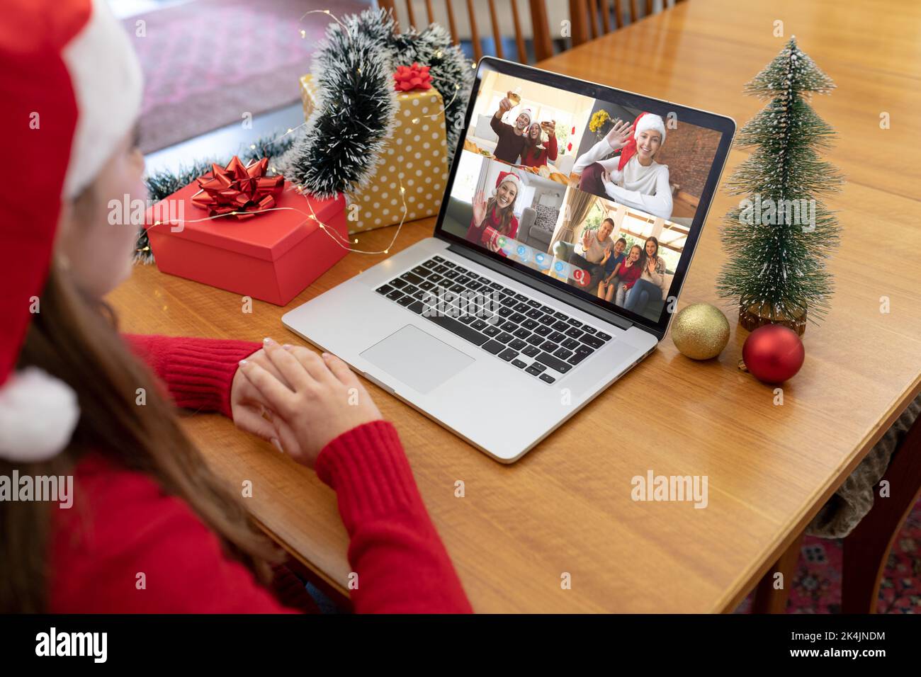 Caucasian woman in santa hat making laptop christmas group video call ...